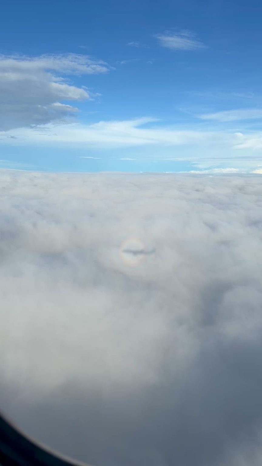 Rainbow halo around airplane shadow on cloud over Singapore – Oddly ...